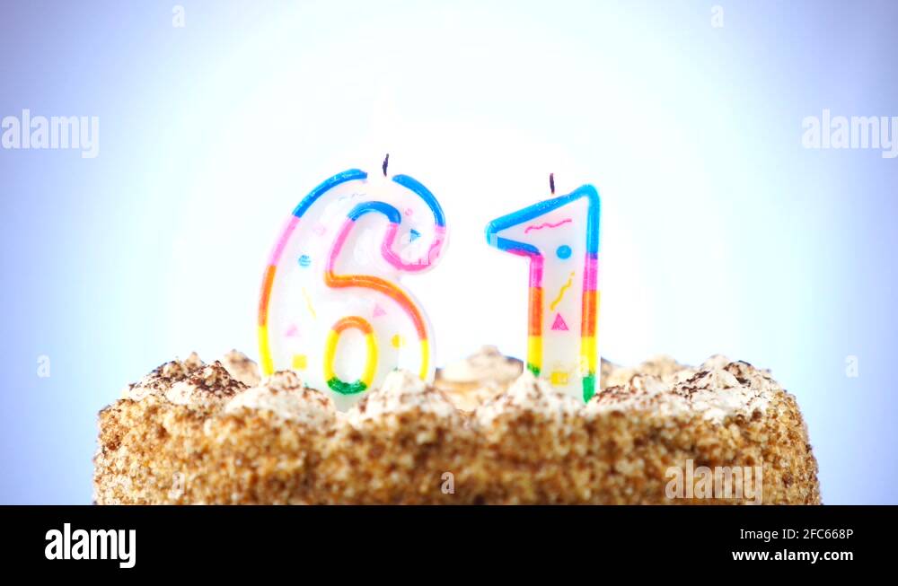 Birthday cake with a burning birthday candle. Number 61. Background ...