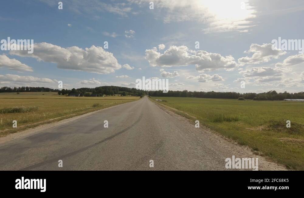 Driving on farmland road. Frontal window view for car composites green ...