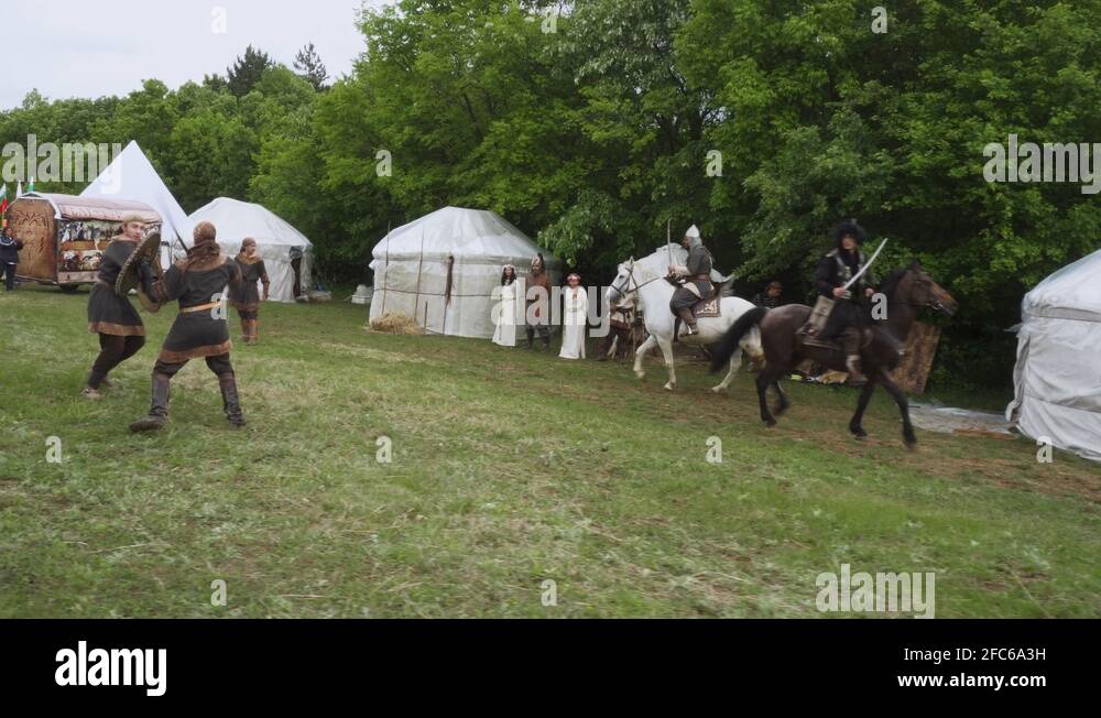 Two men fights with swords and shields representing Bulgars warriors on ...