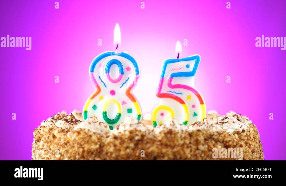 Birthday cake with a burning birthday candle. Number 85. Background ...