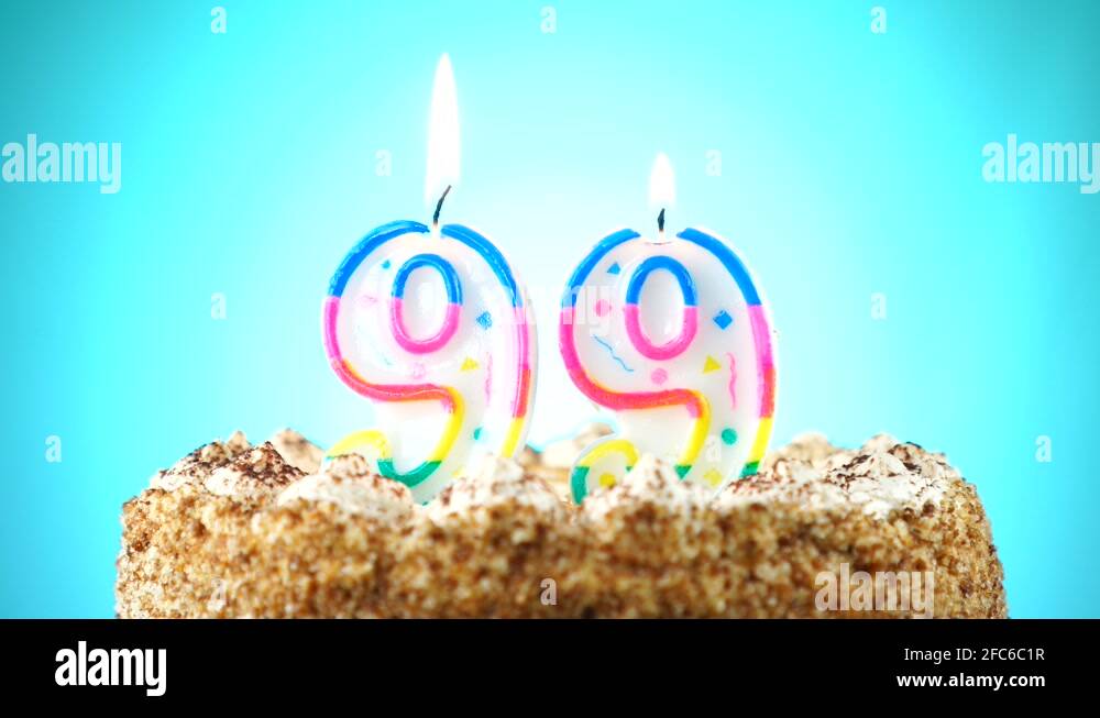 Birthday cake with a burning birthday candle. Number 99. Background ...