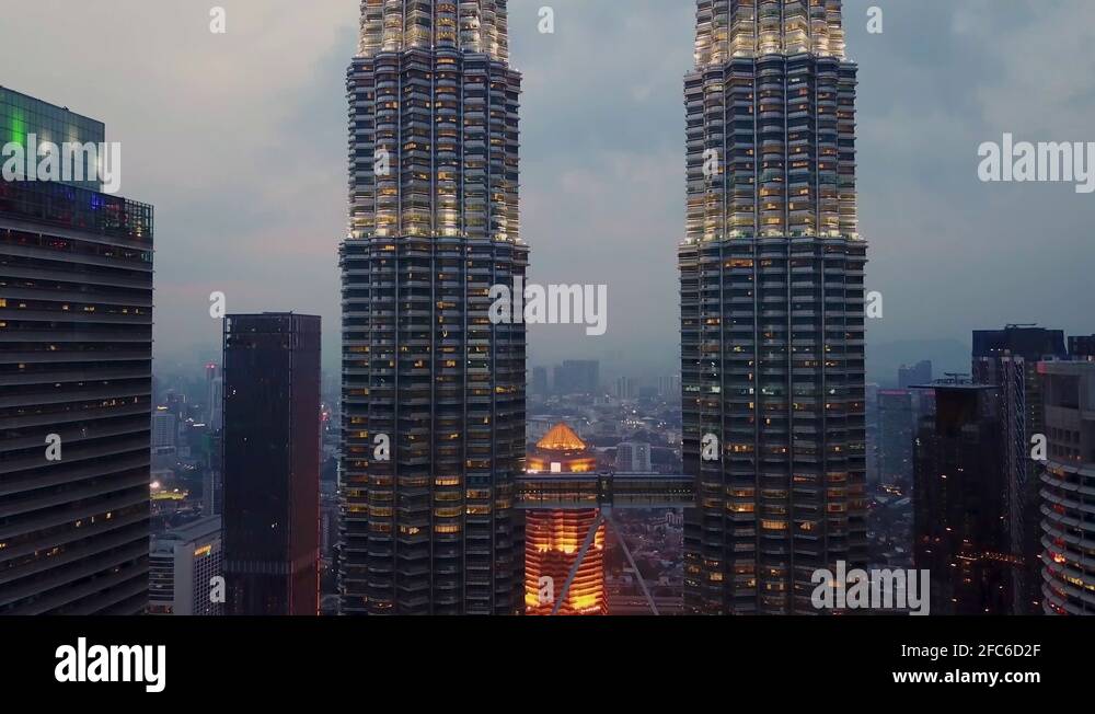 Petronas Twin Towers skybridge at night with KL background, aerial ...