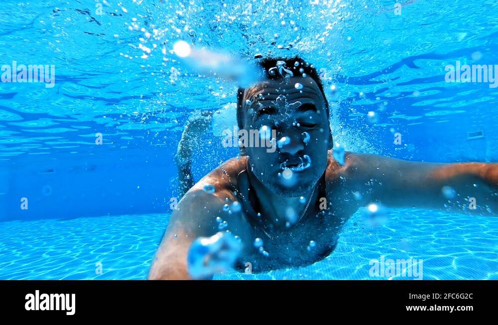 Man swims with underwater camera inside the swimming pool Stock Video ...