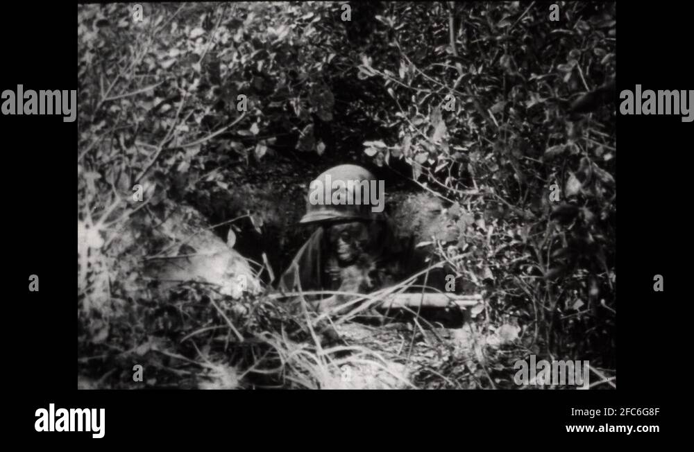 1940s: Explosion by soldier in trench. Rear view of soldier, shots fire ...