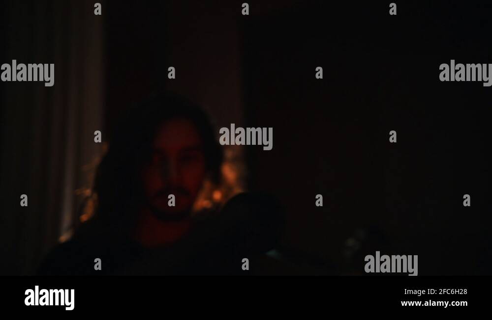 A young man with long hair walking to the mic on the stage - smile and ...