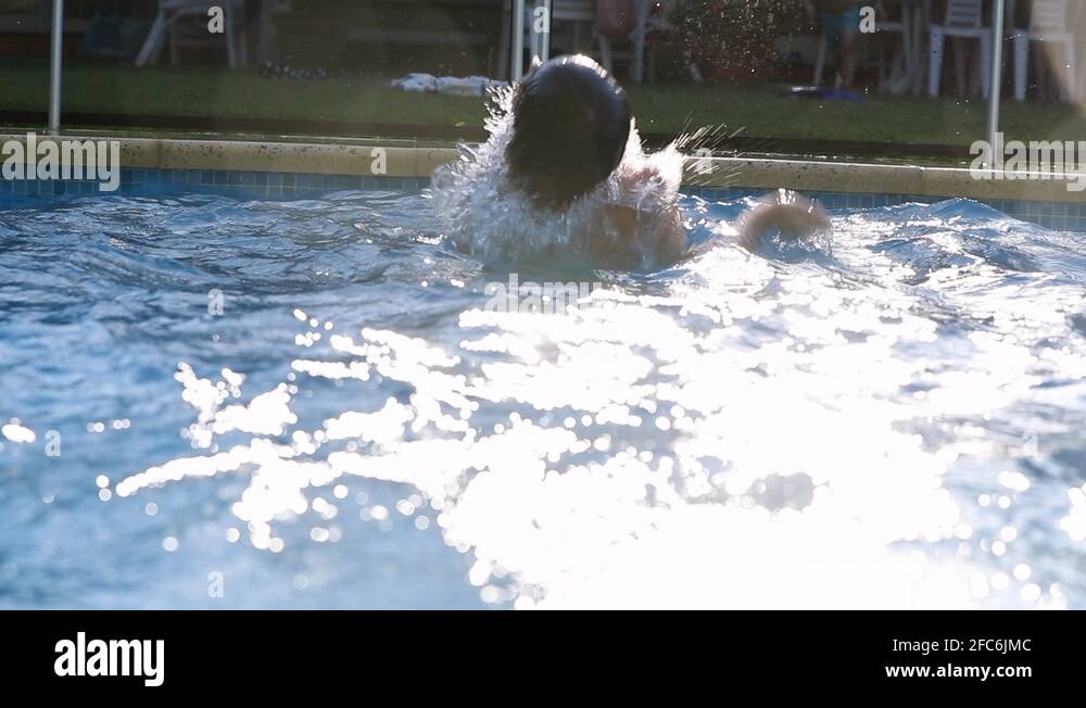 Kid at the swimming pool, young boy emerging from water Stock Video ...