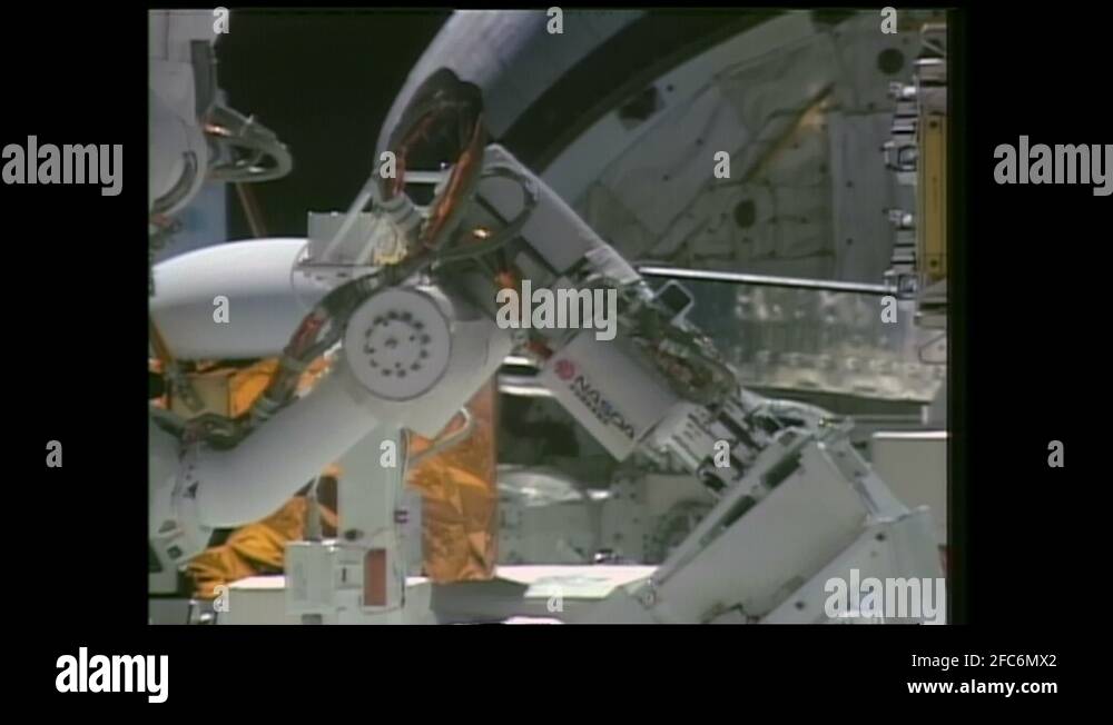 1990s: Robotic arm on space shuttle. Astronaut speaks in cabin. Woman ...