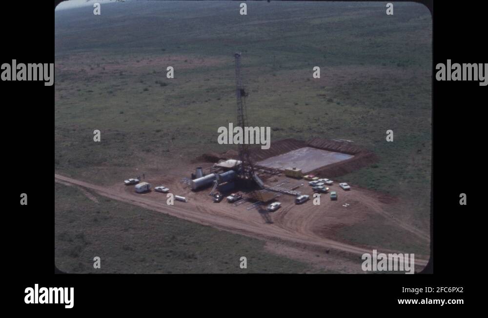 1960s: Aerial view of oil rig by reservoir Stock Video Footage - Alamy