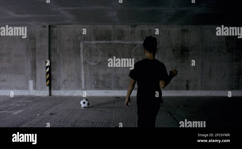 Teenager kid boy soccer player using a spray paint to draw goals on a ...
