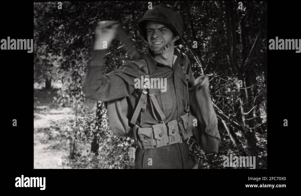 1940s: Soldier putting on backpack. Soldiers in truck. Soldier pick up ...