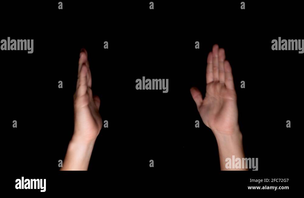 Yoga namaste hand symbol for praying on a black background, medium shot ...
