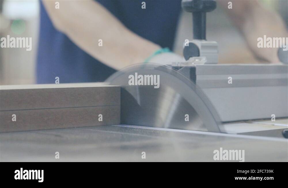 Production circular saw. Large circular saw close-up. A man works on a ...