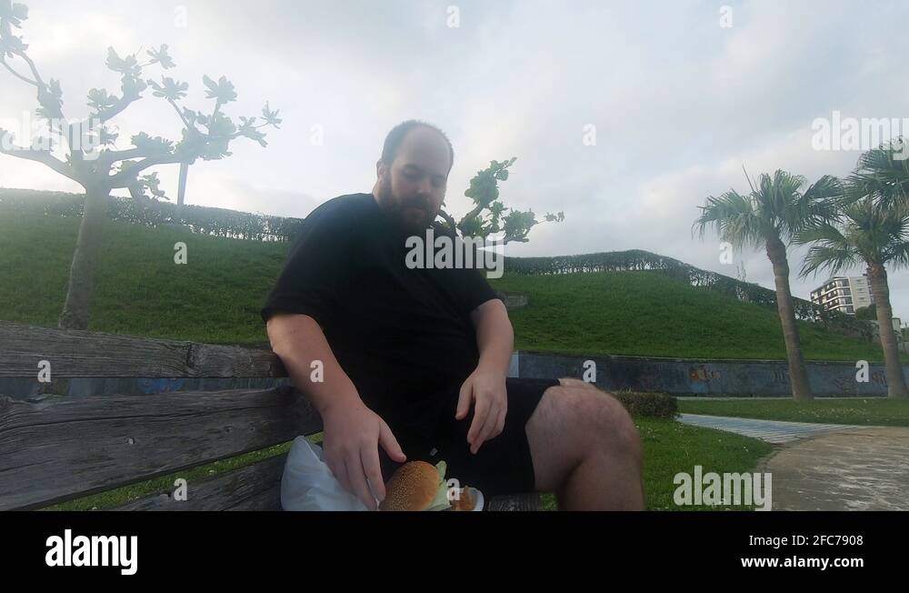 Fat man eating chips Stock Videos & Footage - HD and 4K Video Clips - Alamy