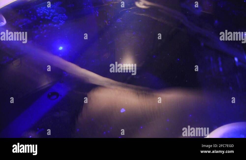 Dry ice drops are falling into water and dissolving in a very beautiful ...