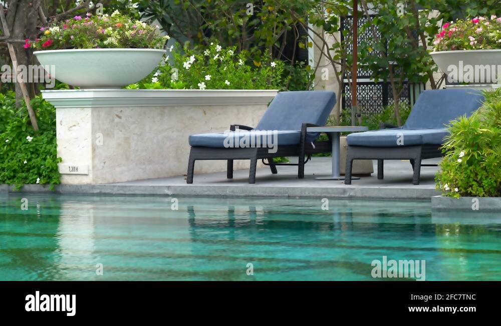 Luxury Hotel Poolside on Windy Day. Pool Beds With Clear Water and ...
