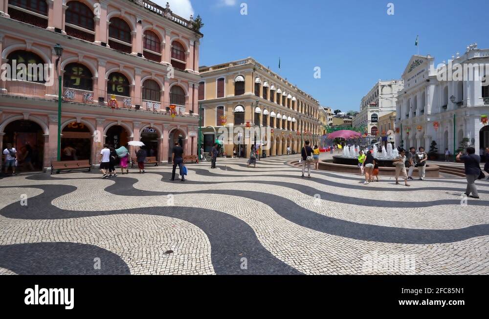 Visitors walk across historic and famous architecture in Macau city ...