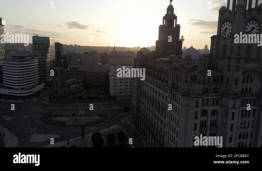 Liverpool city iconic Liver building skyline during glowing sunrise ...