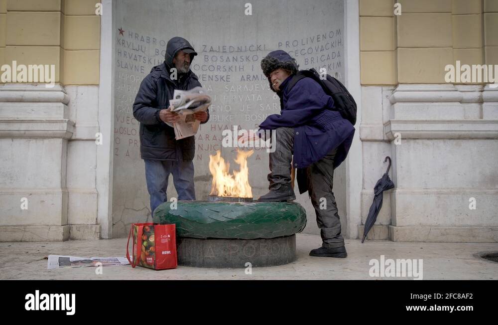 Two homeless people find shelter in the eternal flame, the monument of ...