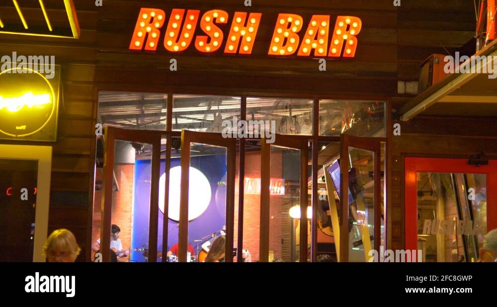 Rush Bar exterior sign of a pub and look through the glass door of band ...