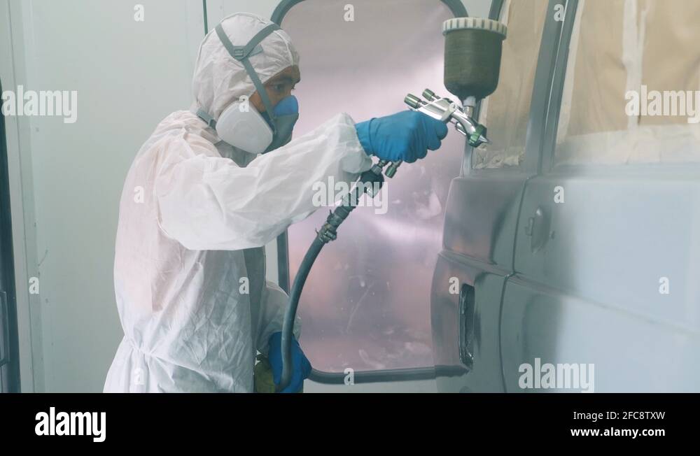 Industrial spray painting process. Paint-spraying gun is getting used ...