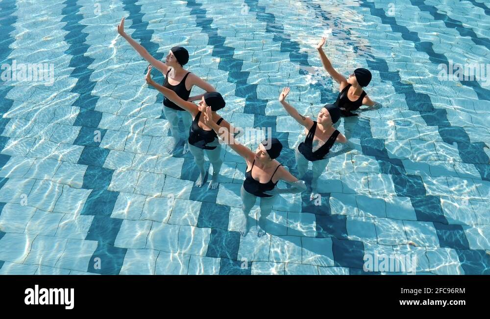 Five young girls are standing in the pool. Girls do water aerobic Stock ...