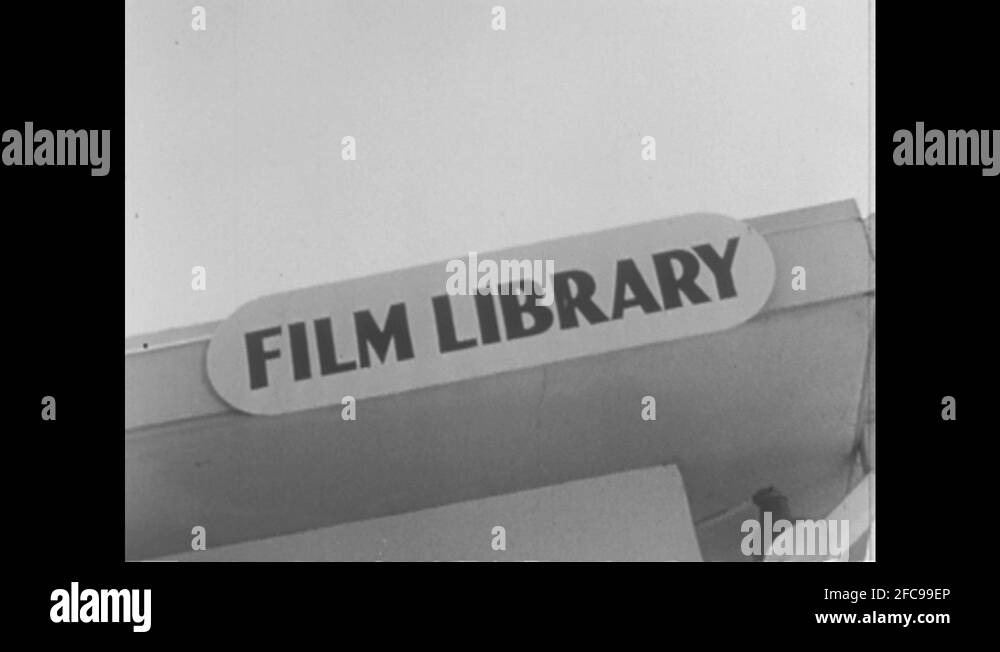 1950s: film libraries, woman showing a man visual aids for teaching ...