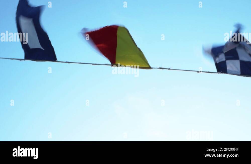 Signal code flags flutter on a strong wind Stock Video Footage - Alamy