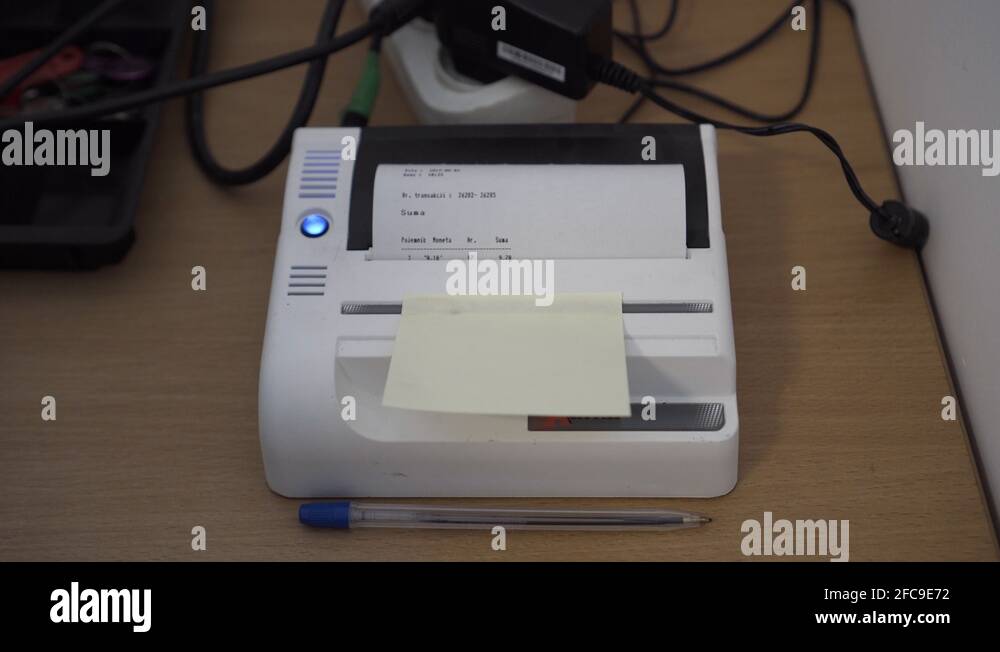 Thermal printer on messy desk prints summary of coin counting done by ...