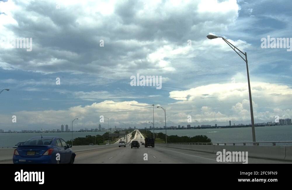 Driving on Julia Tuttle Causeway bridge inside car view of Miami ...