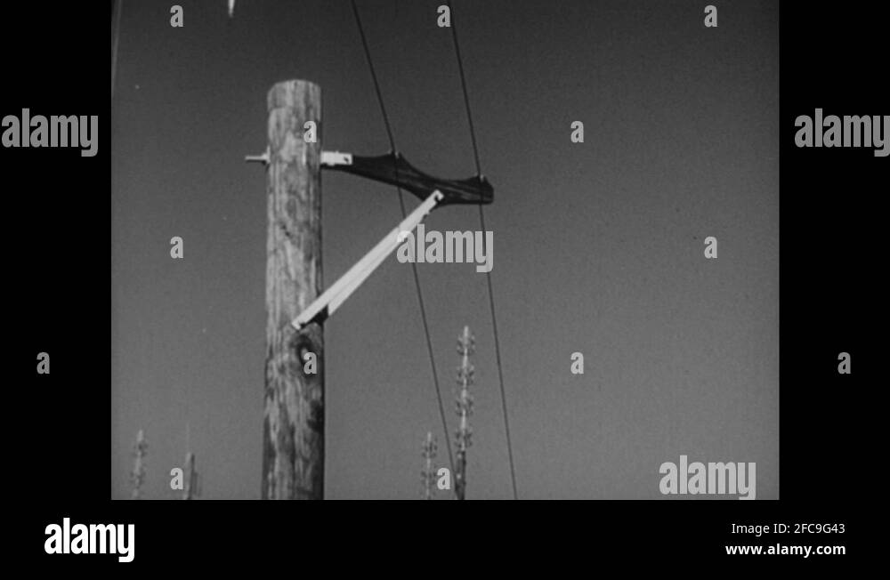1940s: UNITED STATES: electrical poles and station. Plane in sky. Early ...
