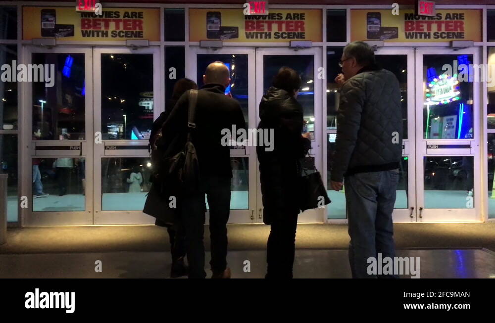 Motion of people entering main entrance for watchingie at cinema with ...