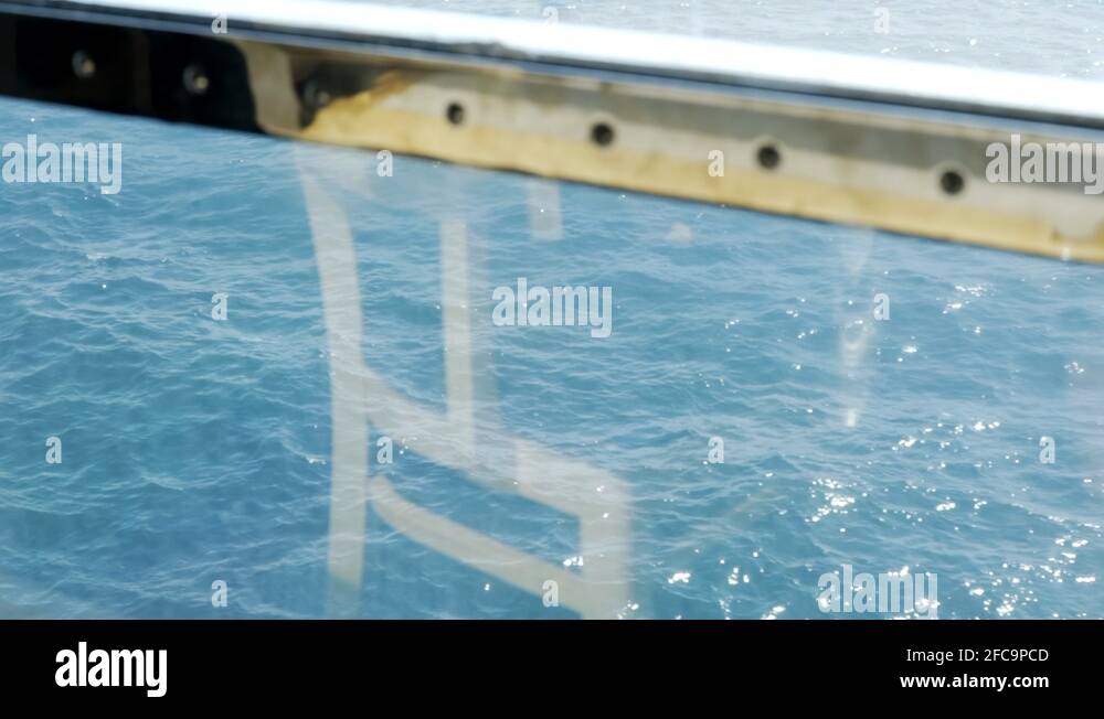 Slo-motion of the ferry. You sea the water with a reflection of the ...