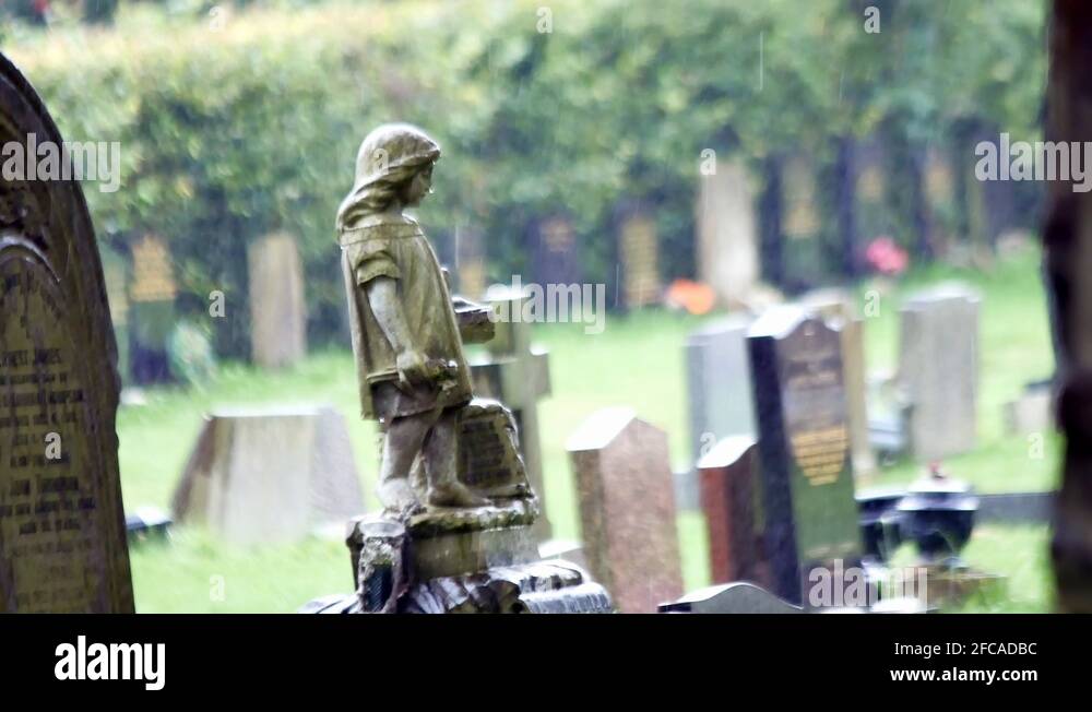 Angel girl stone grave headstone in rainy cemetery. Sad, mourning ...