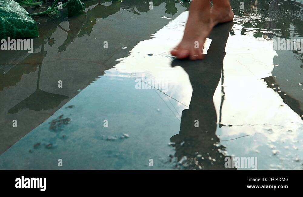 Young boy shadow silhouette playing sliding his barefoot side to side ...