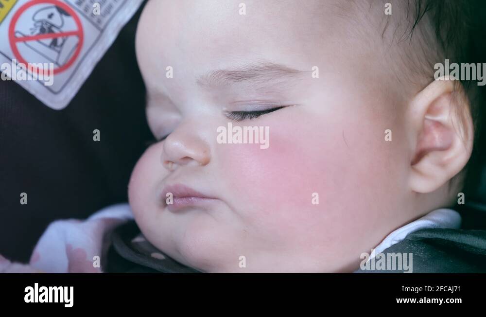 Cute baby girl sleeping in her car seat in the car while driving Stock ...