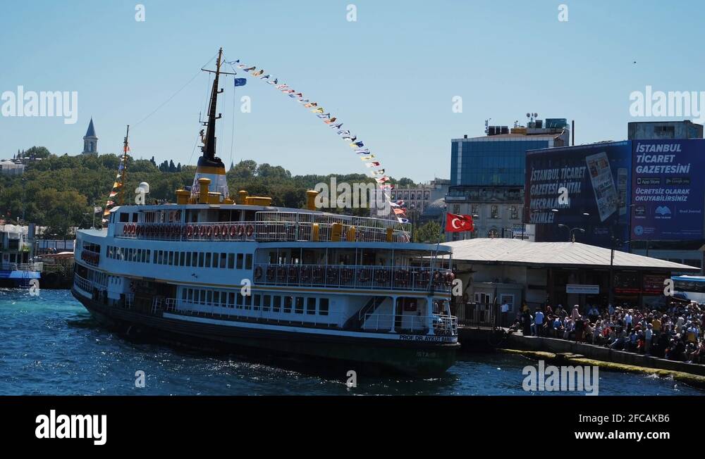 Ferry anchoring in Istanbul, with turkish flag on the back in front of ...