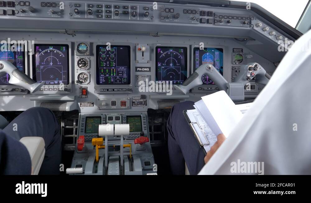 View of the cockpit of an Embraer 135 aircraft being operated by two ...