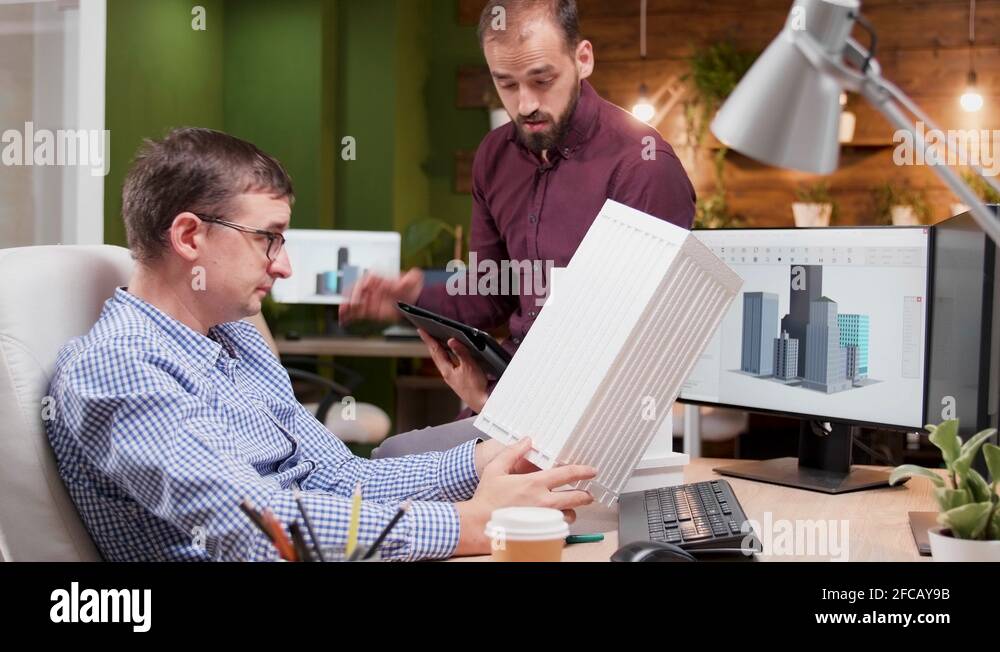 Architect of the new building at the scale model Stock Videos & Footage ...