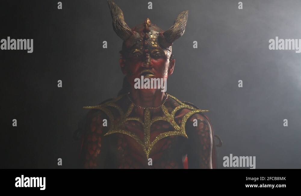 Golden armor on an evil demon with massive horns and red eyes, in the ...