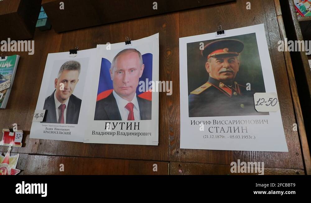 3 Posters of Putin, Stalin and Krasnoselski in a kiosk in Transnistria ...