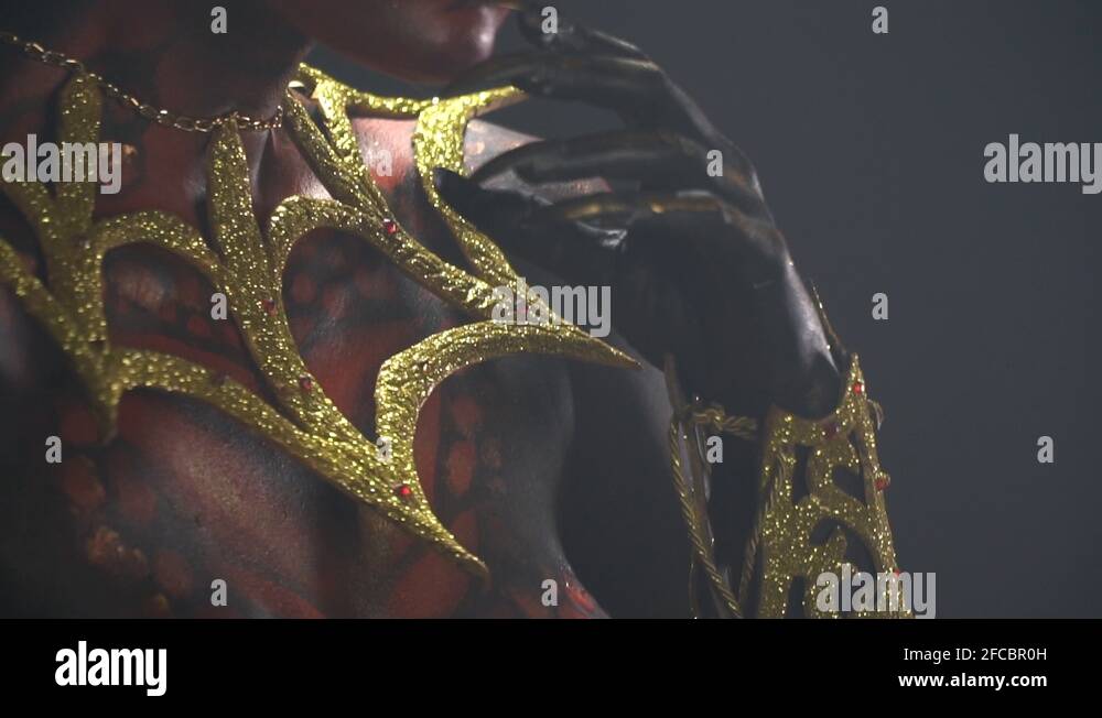 Golden armor of a creepy female demon with red and black skin Stock ...
