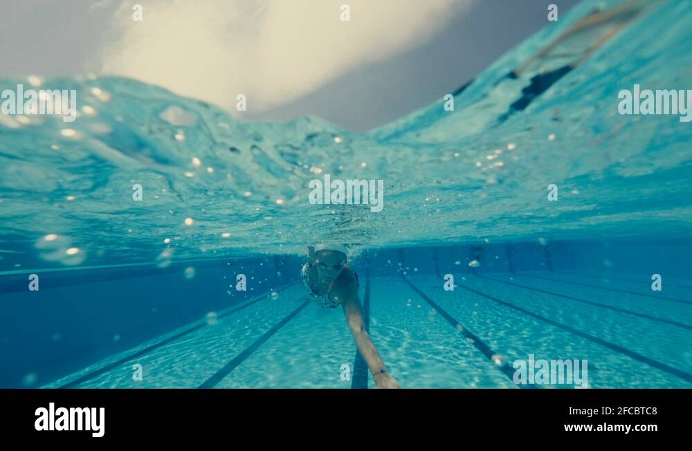 Woman swim the front crawl in an olympic pool day sunny slow motion ...