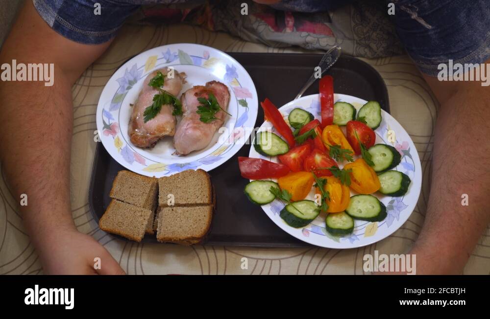 Man eating dinner while lying on stomach in bed top view Stock Video ...