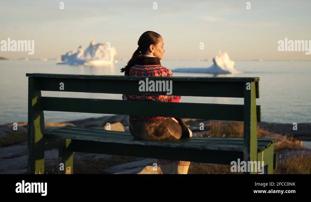 Sunlight falling on woman wearing traditional dress while sitting on ...