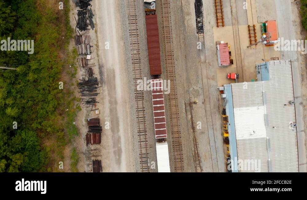 4k top down view showing train cars leaving a train station ...