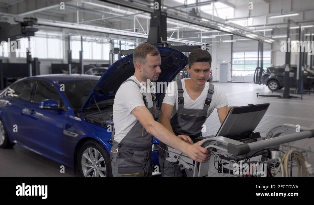 Mechanic using computer auto repair Stock Videos & Footage - HD and 4K ...