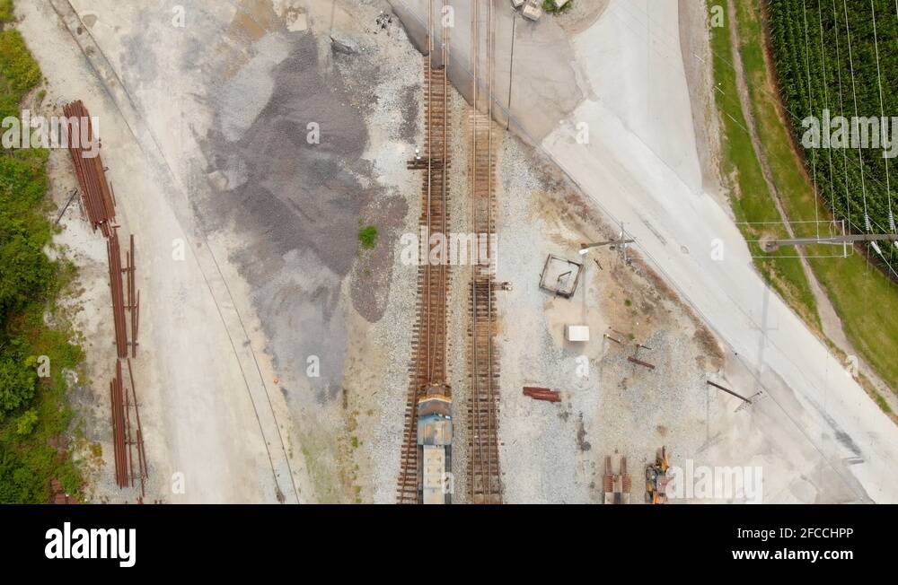 4k top down showing the engine of the train starting at the bottom ...