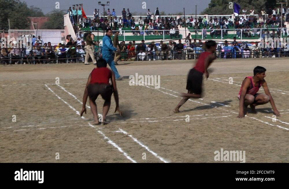 Boys playing kho kho, a traditional Indian game, try to catch an ...
