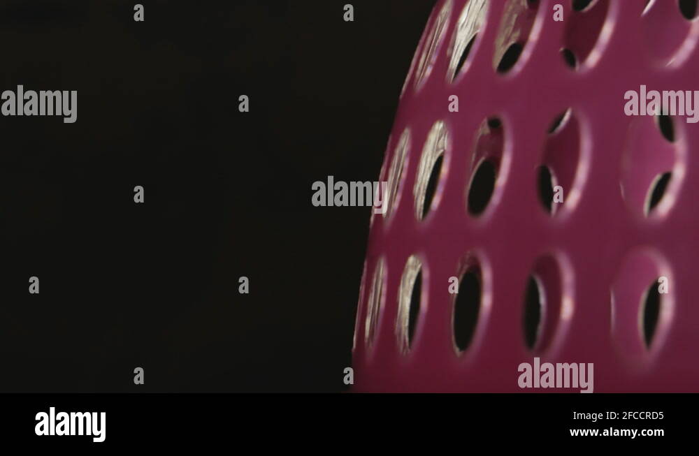 spinning lilac sphere with holes and backlight, background Stock Video ...