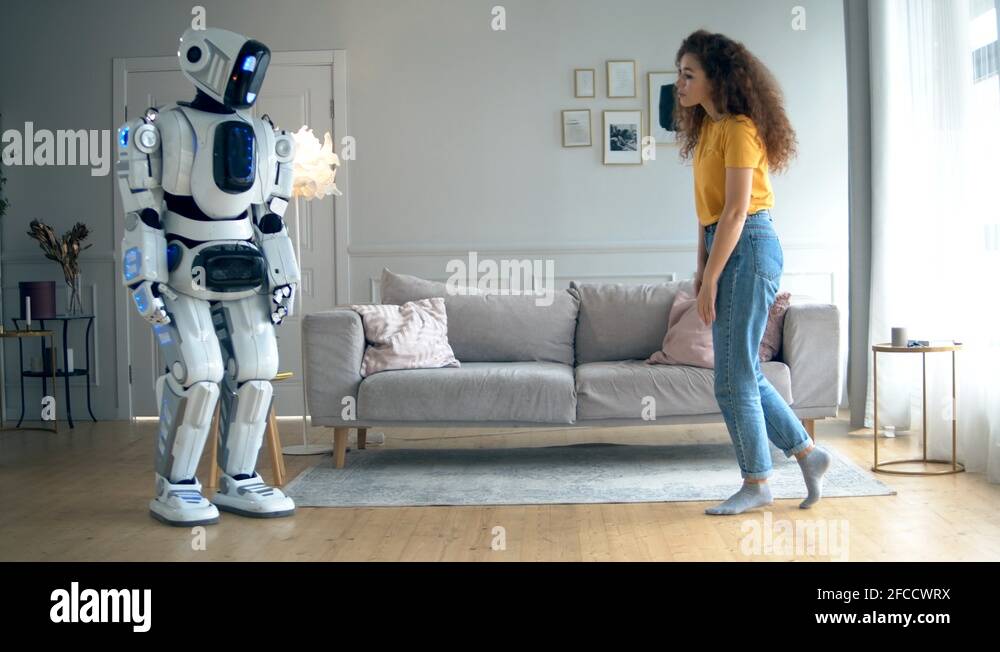 Human-like cyborg and the lady are touching hands. Smart home concept ...